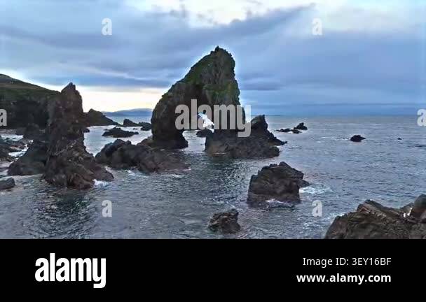 Dramatic Ocean Arch Rock Formation Against A Moody Cloudy Sky Stock ...