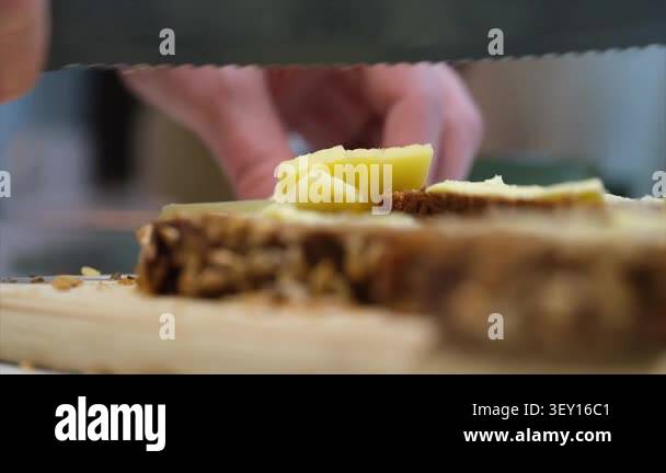Close up footage of slices of seeded bread topped with cheese on a ...