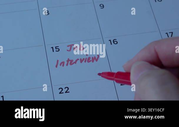 Job interview text in red, written on desk calendar. Employment or ...