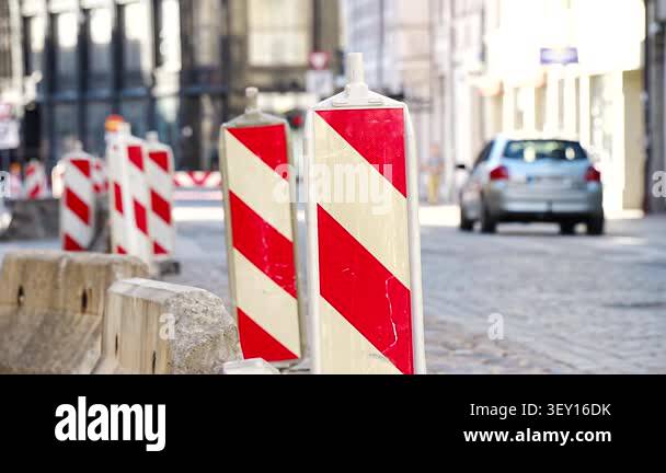 Concrete temporary blocks coupled with red reflective hazard signs on a ...