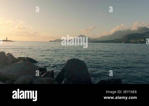 Azul sea washes rocky coast under open sky waves hit stones mountains ...