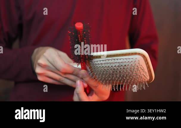 Close Up of Hands Holding Round and Paddle Hair Brushes for Hair Care ...
