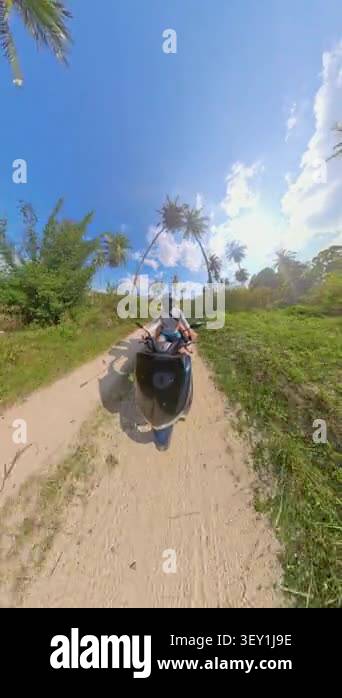 Vertical video. Tropical Adventure Travel, Man Riding Scooter on Sandy ...
