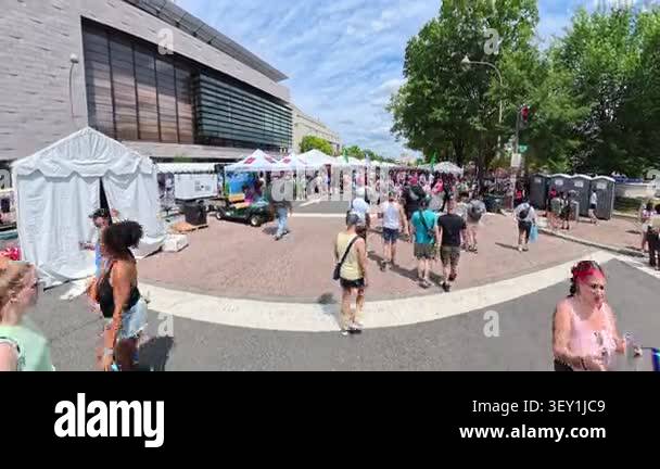 Visitors explore colorful Pride street market near the Capitol during ...