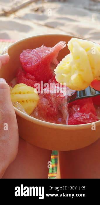 Vertical video. First Person View Of Hand Picking Mini Pineapple Piece ...