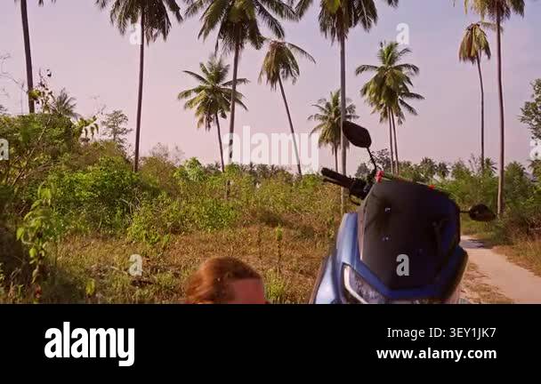 Woman Sitting Near Scooter Drinking Water Under Palm Trees in Tropical ...