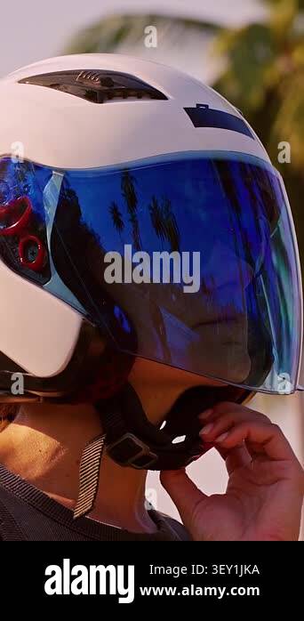 Vertical video. Woman Removing Helmet While Wearing Sunglasses in ...