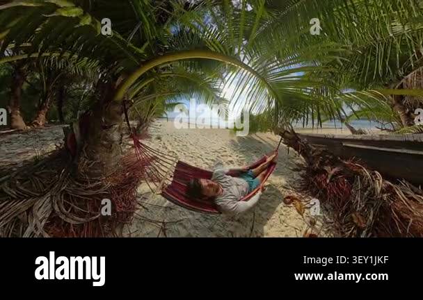 Tropical Palm Shade Relaxation, Man Resting in Red Hammock Between Palm ...