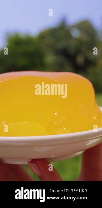 Vertical video. Playful Food Motion, Spoon Tapping Yellow Jelly on ...