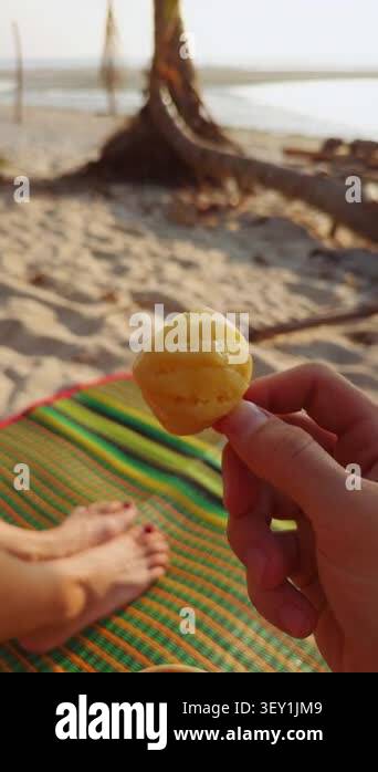 Vertical video. First Person View Of Hand Holding Mini Pineapple Piece ...