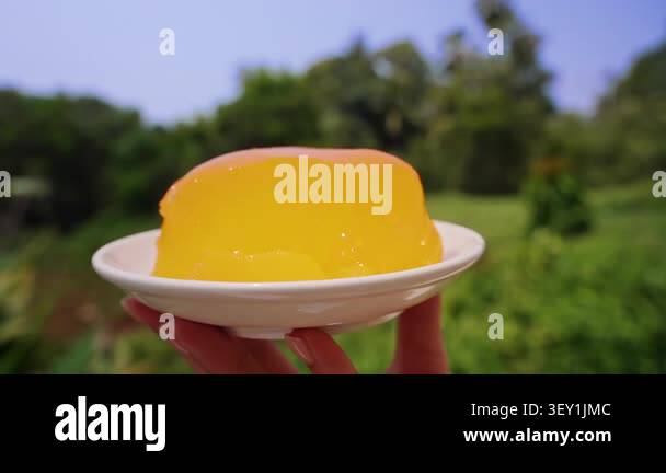 Playful Food Motion, Spoon Tapping Yellow Jelly on White Plate in Slow ...