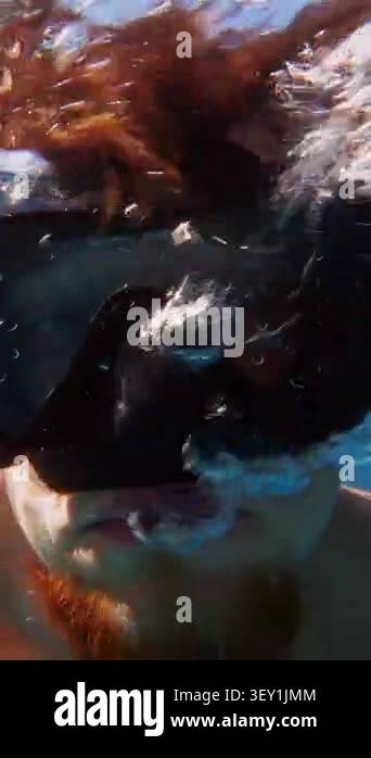 Vertical video. Underwater Front View Of Man Swimming With Diving Mask ...