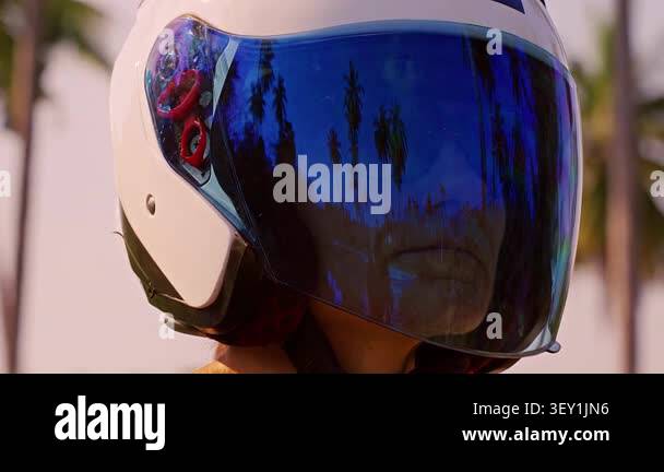 Close Up of Helmet with Reflective Visor Showing Palm Trees Reflection ...