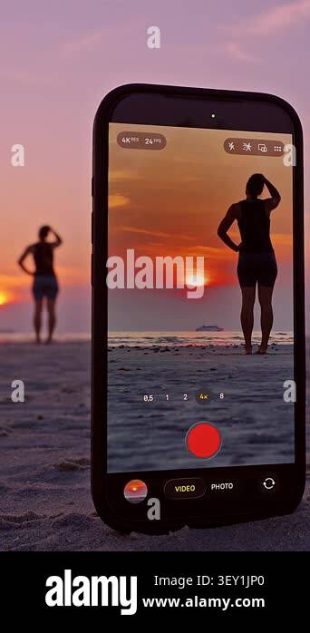 Vertical video. Smartphone Recording Woman Standing on Beach During ...