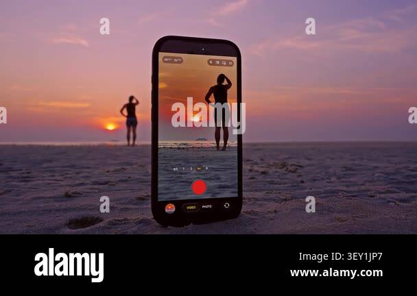 Smartphone Recording Woman Standing on Beach During Sunset Framed in ...