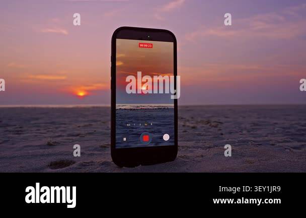 Smartphone Recording Sunset Over Ocean on Beach with Empty Frame After ...