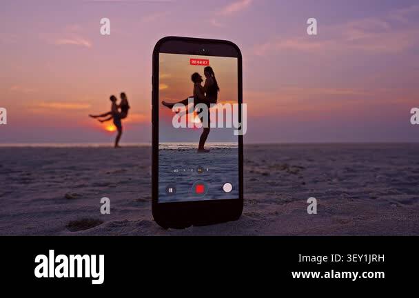 Smartphone Recording Woman Leaping into Man Arms and Being Lifted on ...