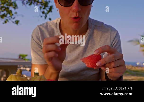 Close Up of Hands Holding Pomelo Slice and Separating Juicy Segments at ...