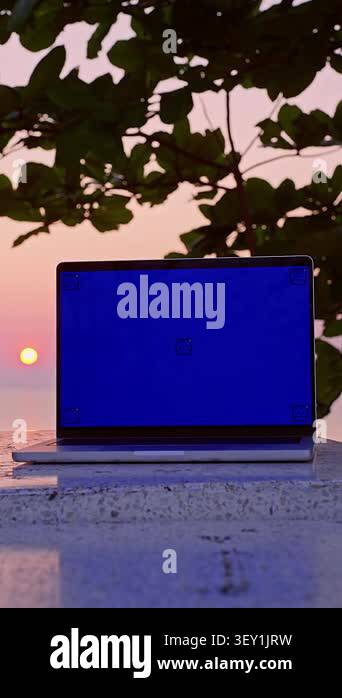 Vertical video. Laptop with Blue Screen Mockup Template on Outdoor ...