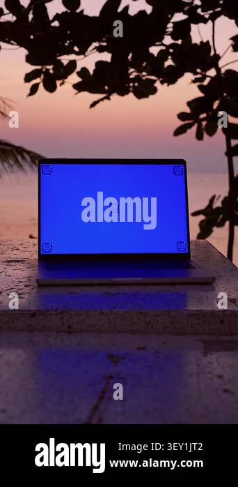 Vertical video. Laptop with Blue Screen Mockup on Outdoor Table at ...