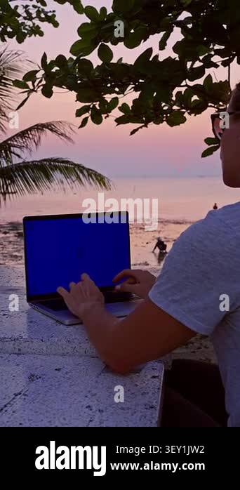Vertical video. Woman Working on Laptop with Blue Screen Mockup ...