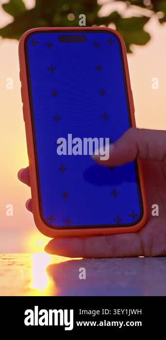 Vertical video. Hand Holding Smartphone with Blue Screen Mockup ...