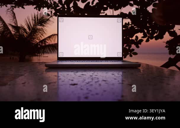 Hand Closing Laptop With Blank Screen On Table Against Tropical Sunset ...