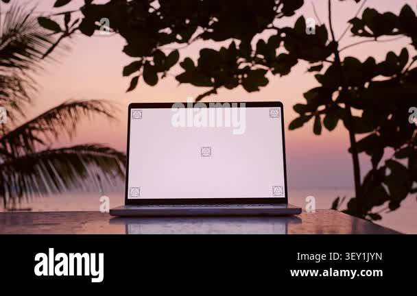 Laptop with White Screen Mockup on Outdoor Table at Sunset with ...