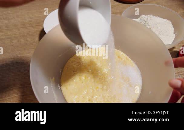 Sugar Being Poured Into Soft Dough Mixture In Large Bowl On Wooden ...