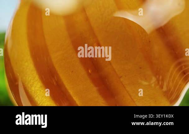 Golden Honey Drop Hitting Lens And Spreading Across Surface Creating ...
