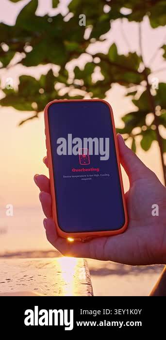 Vertical video. Smartphone Screen Showing Overheating Warning Message ...