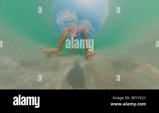 Underwater Low Angle View Couple Walking On Sandy Bottom With Strong ...