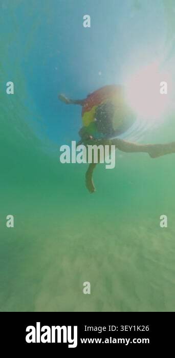 Vertical video. Underwater View Woman Holding Inflatable Ring With ...