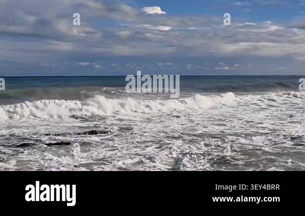 rocky shoreline waves crashing with foamy spray, rugged boulders ...