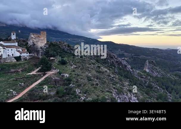 Aerial castle ruins dusk over scrubland watchtower perched on rocky ...