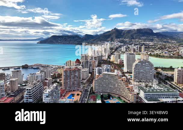 Aerial coastal skyline with turquoise sea and sunlit pools, highrise ...