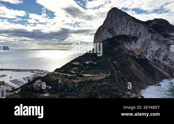 Coastal headland overlooking shimmering sea at sunrise, limestone cliff ...