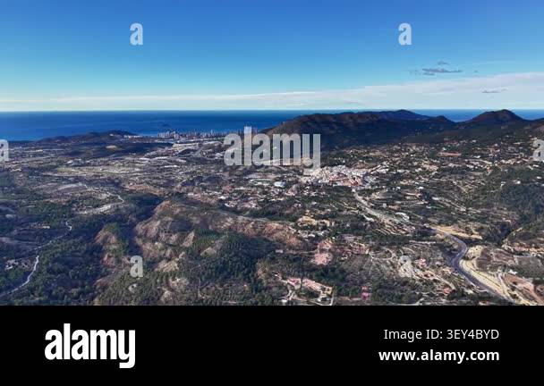 Aerial coastline town panorama under clear blue sky, pilot survey ...