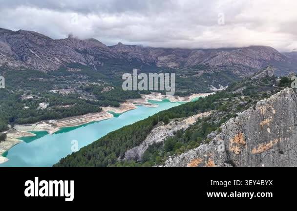 Turquoise lake mountain valley panorama, aerial view of winding ...