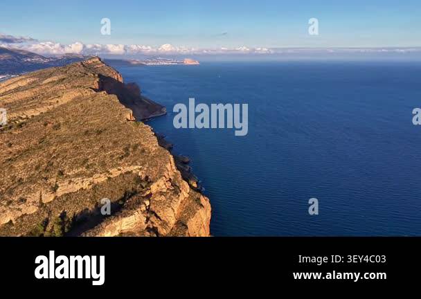 Azure coastline with steep rocky cliffs, coastal ecologist mapping ...