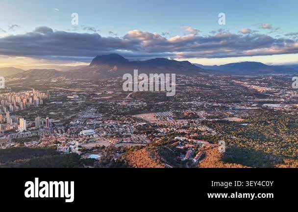 Sunrise aerial over forested outskirts, showing tree canopy, urban ...
