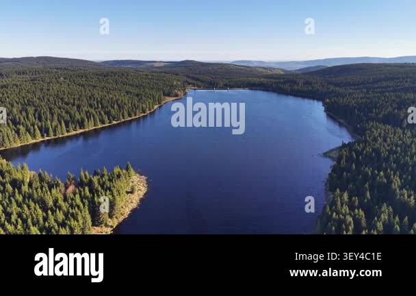 Aerial reservoir scene with visible bridge calm deep blue water ...