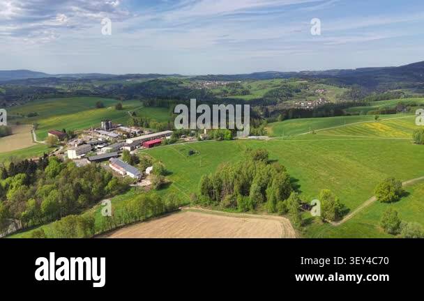 Aerial view farm complex and fields showing barns, silos, machinery ...