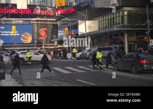 Busy downtown intersection with pedestrians near the Scotiabank Arena ...