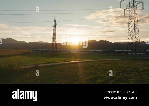 Power lines and electric towers connect across a rural area during ...