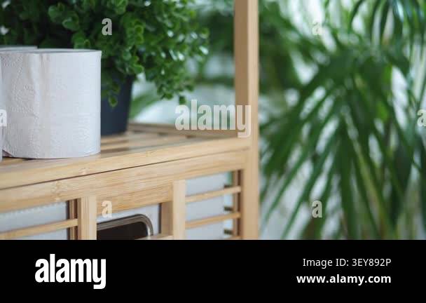 a natural wood finish on a bamboo toilet paper holder Stock Video ...