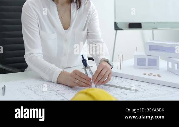 Architect hands measuring and drawing on a blueprint, developing modern ...