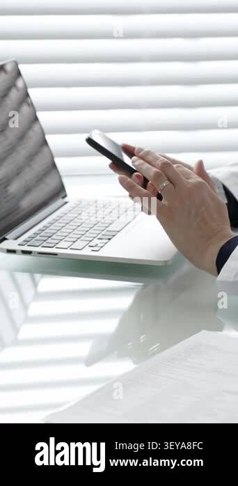 Healthcare professional navigating a mobile application on a smartphone ...