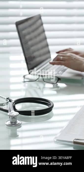 Doctor working on computer, analyzing patient data and medical records ...