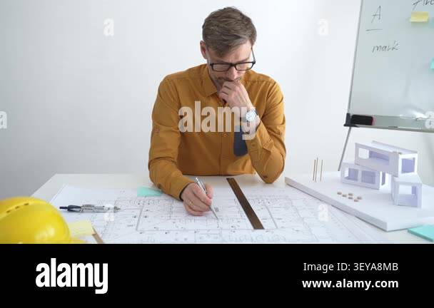 Architect or engineer meticulously drawing and analyzing detailed ...